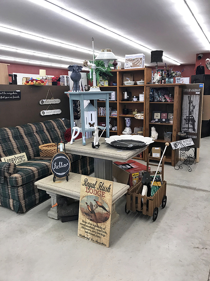 Mid-century meets modern charm in this cozy furniture display. That plaid loveseat has probably heard more family stories than a holiday dinner table.