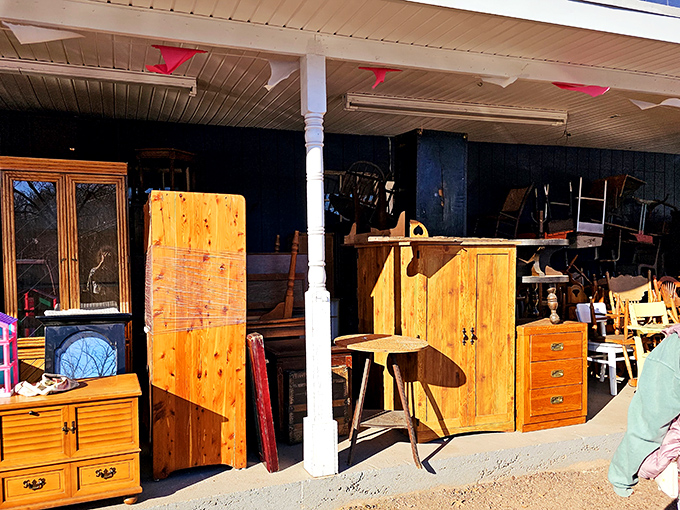 Wooden furniture with stories to tell stands sentinel on the porch, basking in sunlight while awaiting adoption into new homes.