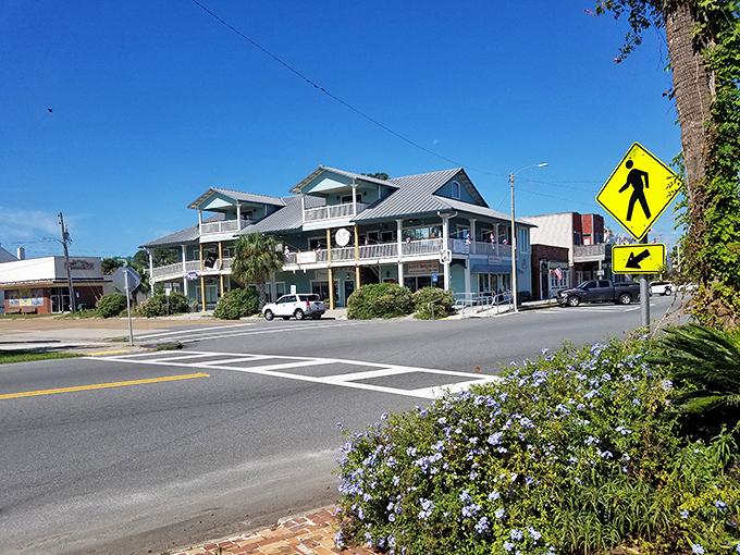 A quiet street corner in Apalachicola captures the town&rsquo;s laid-back charm, where pastel facades and porch-lined buildings invite you to slow down and explore.