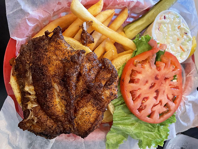 The blackened grouper sandwich&mdash;where spice meets fish in a romance so perfect, you'll want to write sonnets about it. Those fries aren't bad company either.