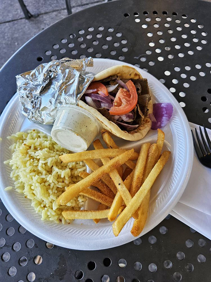 This gyro isn't just a sandwich&mdash;it's a perfect trilogy of seasoned meat, fluffy rice, and crispy fries that makes fast food chains weep with inadequacy.