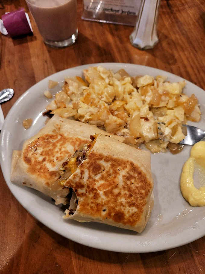 This breakfast burrito isn't trying to win a beauty pageant, but it might just win your heart with those perfectly crispy home fries.