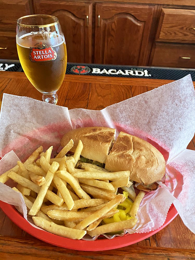 The holy trinity of game day dining: a cold beer, golden fries, and a sandwich that requires both hands and several napkins.