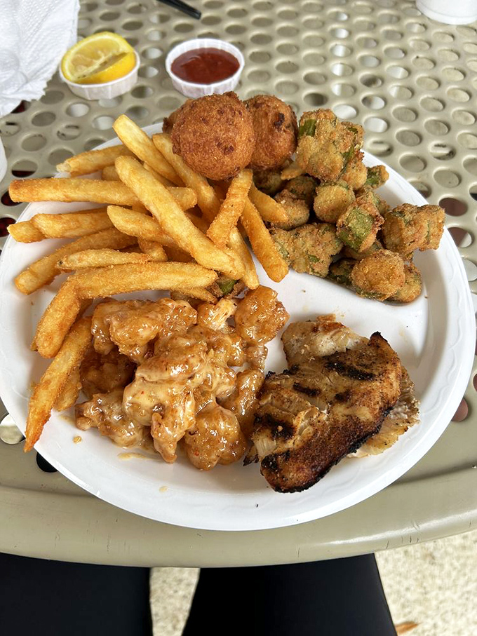 This isn't just a meal; it's a Gulf Coast symphony on a plate&mdash;crispy hushpuppies, golden fries, and that Bang Bang Shrimp stealing the spotlight. 