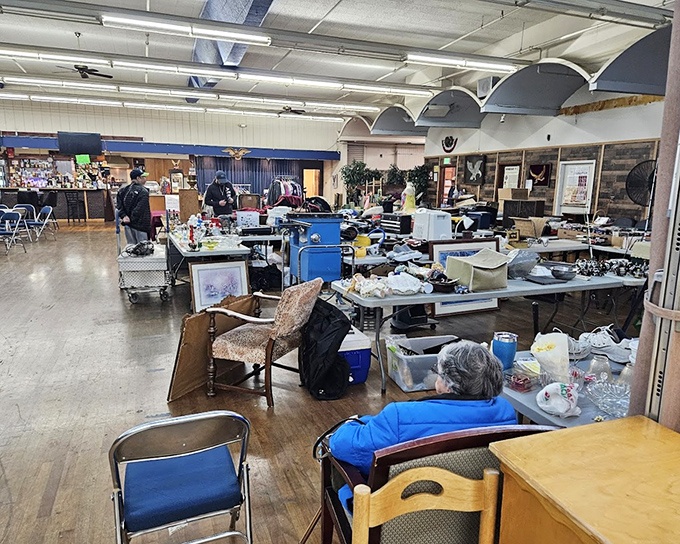 The community hall transforms into a collector's paradise. Empty chairs wait patiently for weary treasure hunters needing a moment's rest.