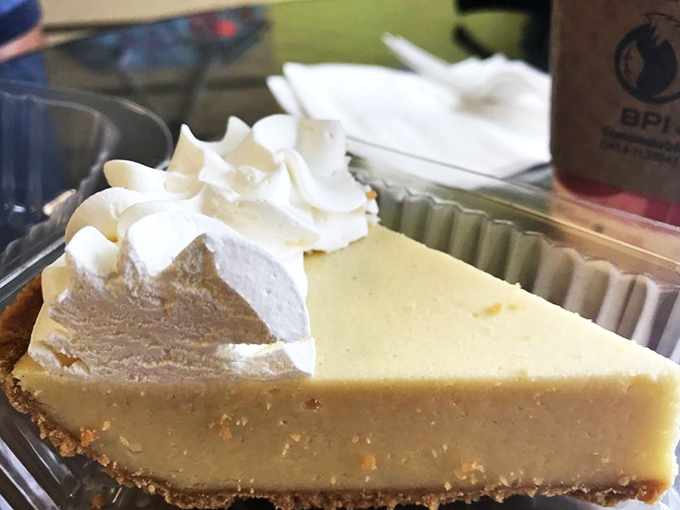 A slice of classic key lime pie that's the perfect balance of tart and sweet, topped with a cloud of whipped cream that's begging to be devoured.