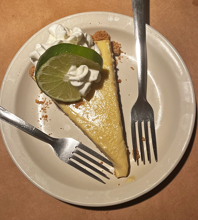 The star of the show: a slice of authentic key lime pie that strikes the perfect balance between sweet and tart, topped with a lime slice and fresh whipped cream.