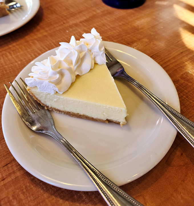 Key lime pie so perfectly yellow it could stop traffic. That dollop of whipped cream isn't garnish &ndash; it's the cloud you'll float on after tasting.