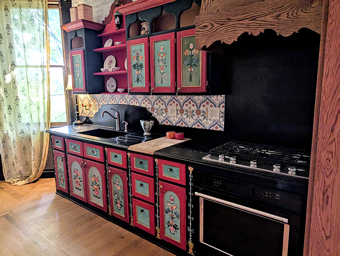 This whimsical kitchen looks like it was designed by Tim Burton during a particularly cheerful phase &ndash; folk art meets Victorian Gothic with a splash of culinary charm.