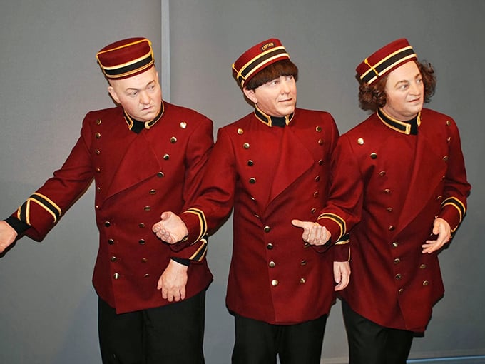 These eerily lifelike figures capture the essence of the trio in their signature bellhop uniforms, forever waiting to mishandle someone's luggage.