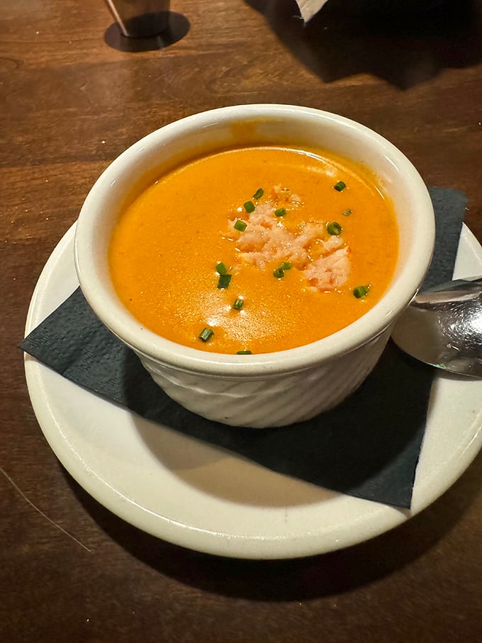 This isn't just soup&mdash;it's a sunset-colored bowl of happiness, garnished with fresh chives and lobster meat that's practically waving hello.