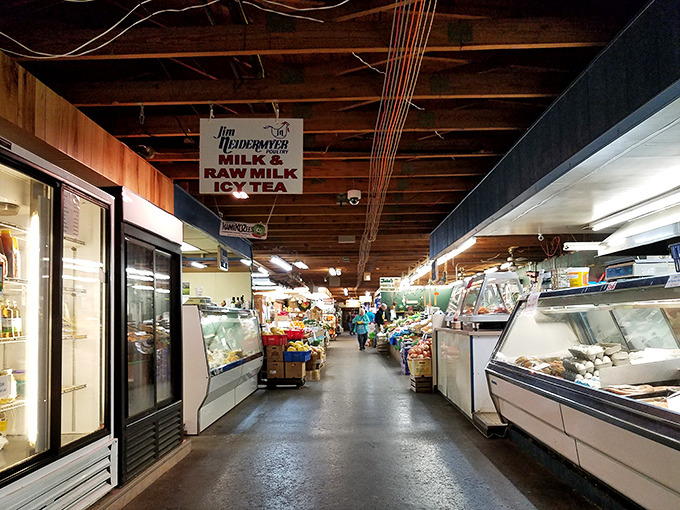The farmers' market corridor beckons with refrigerated cases and fresh offerings. A food lover's paradise nestled within the larger treasure hunt.