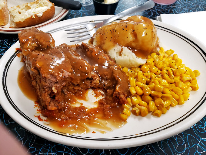 Behold the meatloaf that launched a thousand road trips! Smothered in gravy with mashed potatoes and corn&mdash;comfort food nirvana achieved.