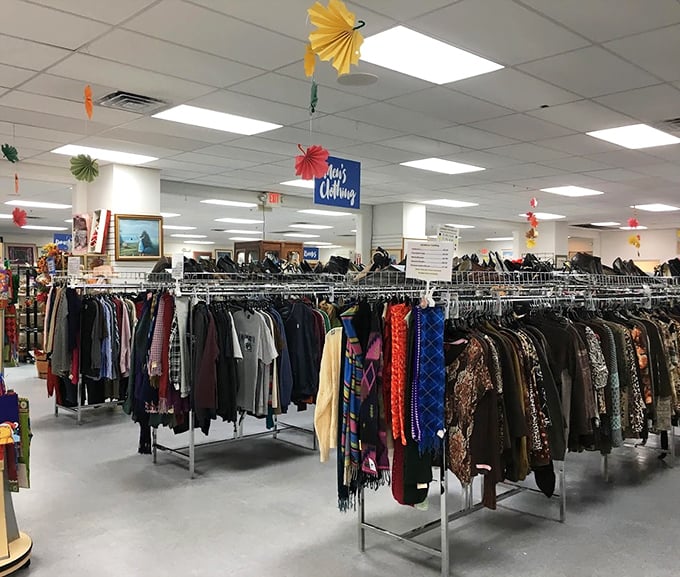 Clothing racks stretching toward the horizon, organized with military precision. The paper decorations add a festive touch to serious bargain hunting.