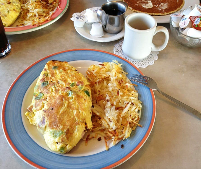 This isn't just an omelet; it's a golden-hued masterpiece with hash browns so perfectly crispy they deserve their own fan club.