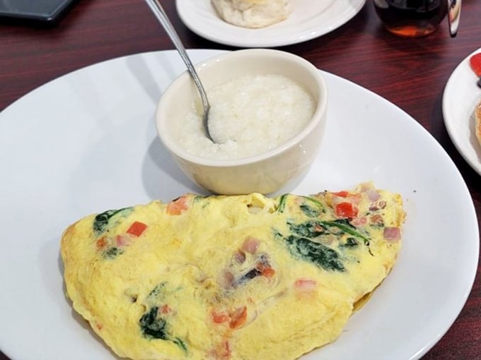 The holy grail of breakfast: a perfectly executed omelet with grits on the side. Simplicity that would make Julia Child weep with joy.