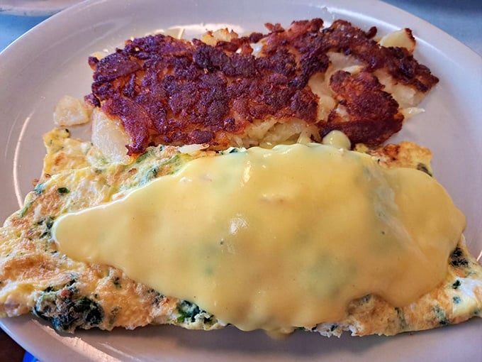This omelet doesn't just whisper "good morning"&mdash;it belts it out with melted cheese cascading over fluffy eggs alongside crispy hash browns.