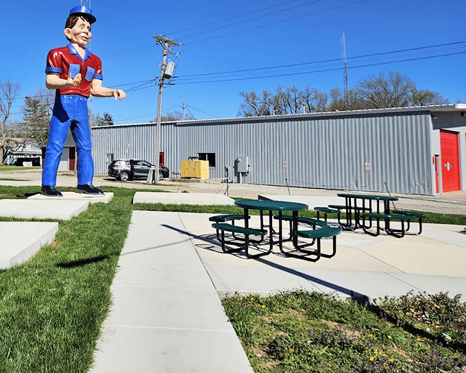 Outside, a towering blue-clad figure watches over picnic tables where road-weary travelers can rest their engines and marvel at these preserved pieces of highway history.