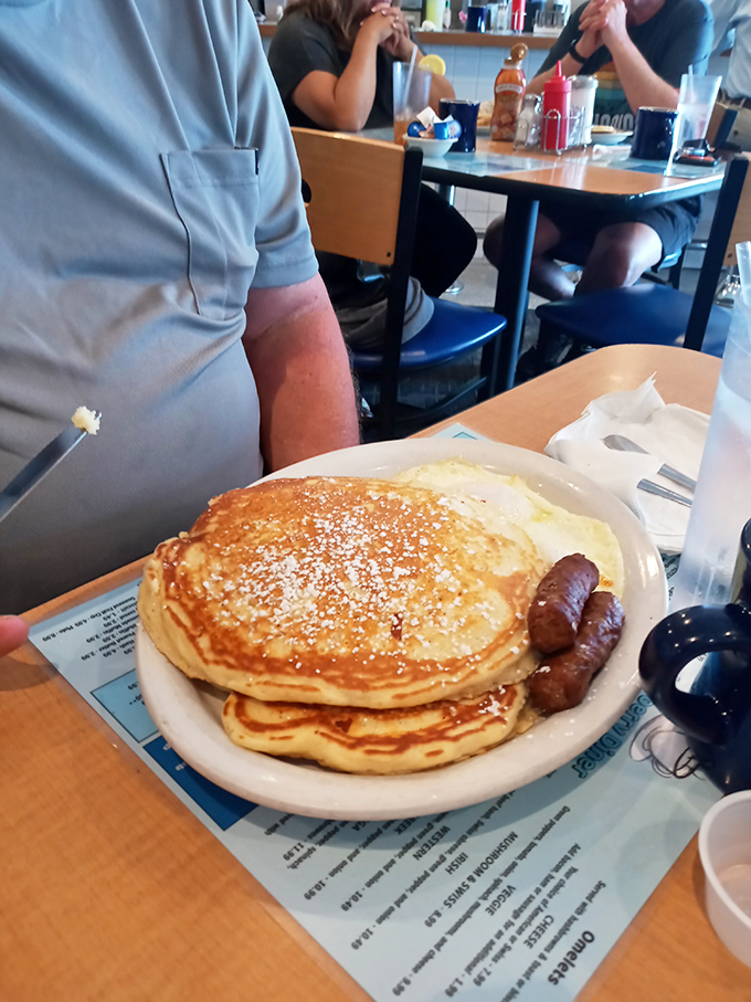Golden pancakes dusted with powdered sugar alongside sausage links&mdash;the breakfast equivalent of a warm hug from your favorite aunt.