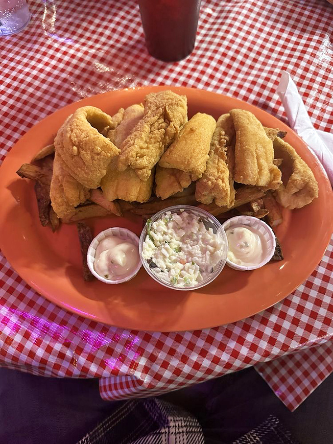 Golden-fried perch that shatters with each bite, served with the holy trinity of sides: tartar sauce, coleslaw, and crispy fries.