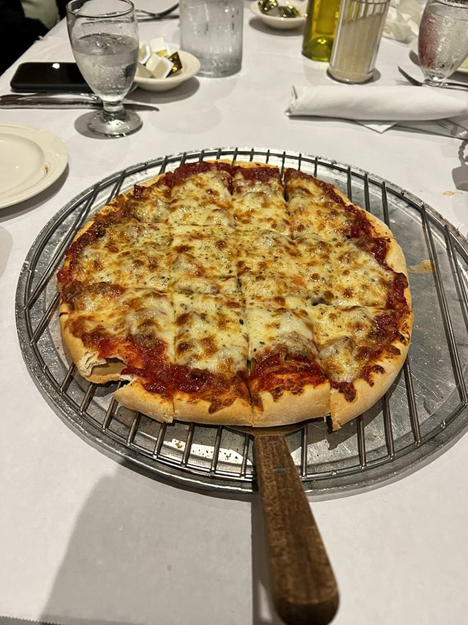 Behold the thin crust pizza in all its glory&mdash;perfectly browned cheese, that ideal sauce-to-crust ratio, and a metal serving stand that means business.