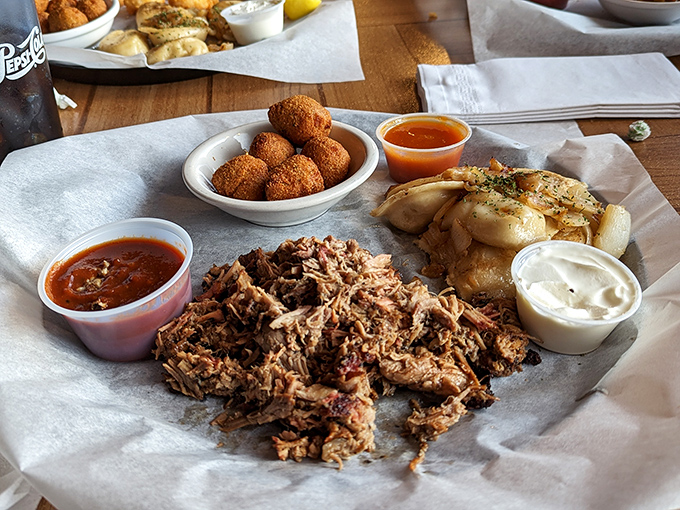 This pulled pork plate isn't messing around. Tender, smoky meat alongside golden hush puppies and pierogies&mdash;a Midwest meets South Carolina love story on a plate.