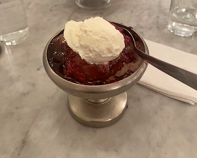 Ruby red raspberry sauce embracing vanilla ice cream like they were made for each other. Spoon-licking moments are mandatory here.