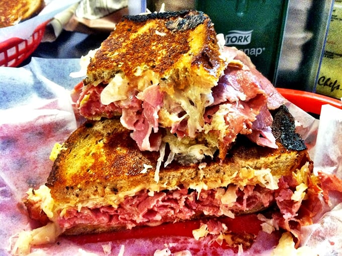 The legendary Reuben in all its towering glory, proving some sandwiches deserve their own zip code.