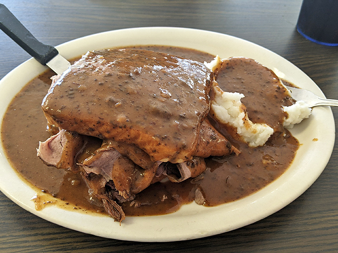 This isn't just roast beef&mdash;it's a gravy-laden monument to comfort food, where mashed potatoes stand ready to soak up every last drop.