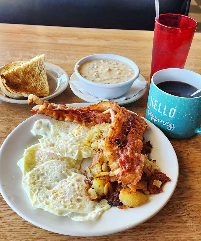 Breakfast nirvana achieved: perfectly runny eggs, crispy home fries, and bacon that should have its own fan club. The soup's just showing off at this point.
