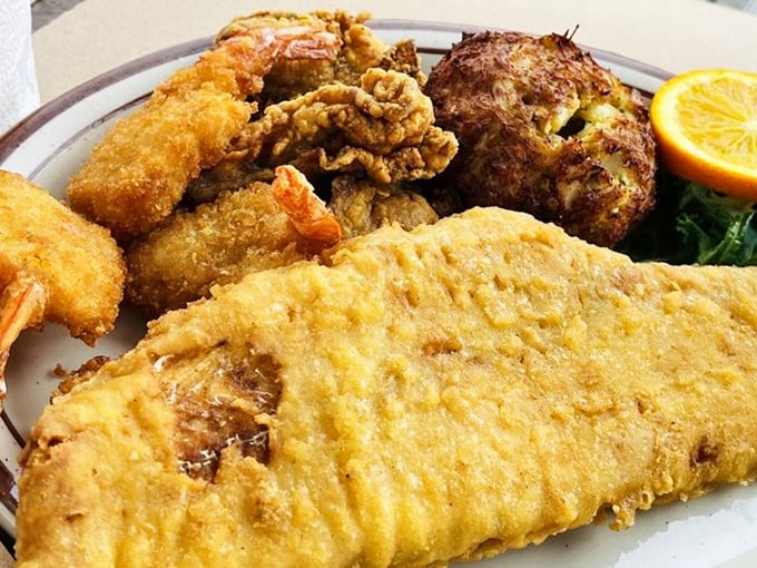 A seafood platter that makes decisions easy&mdash;golden fried fish, plump shrimp, and that crab cake stealing the spotlight like a Broadway veteran.