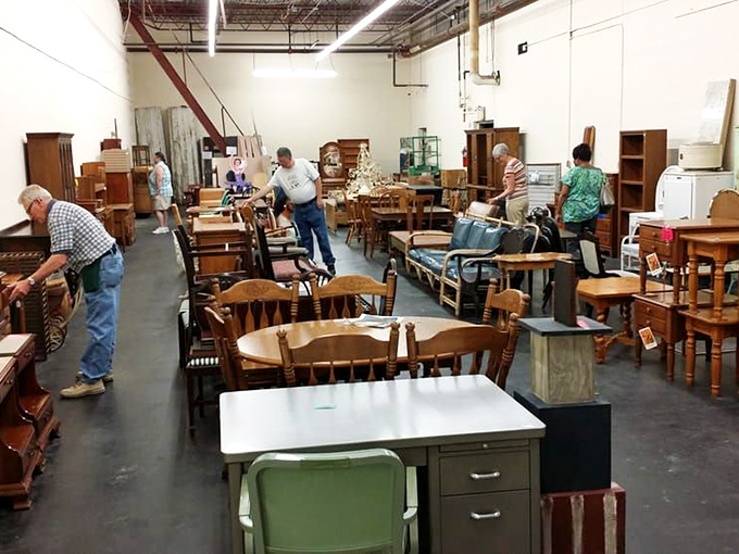 Furniture hunters examine potential treasures in the warehouse section. That mid-century desk might just be writing its next chapter in someone's home office.
