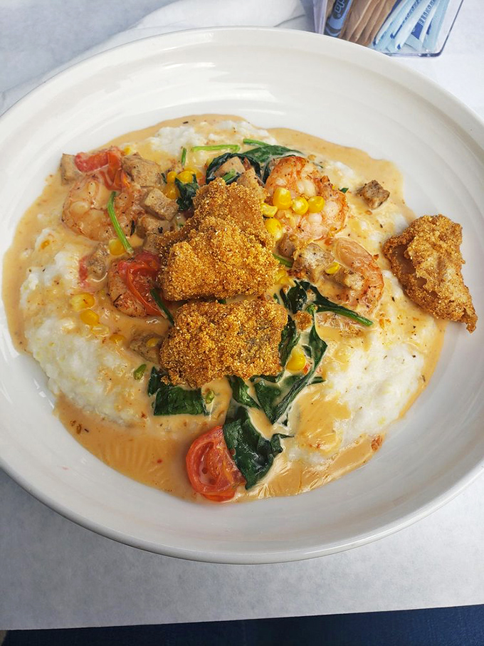 Creamy grits cradle perfectly seasoned shrimp while crispy catfish stands proudly atop this Southern symphony. Comfort food that's dressed for a night out.