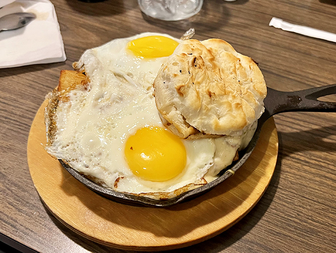 Behold the sizzling skillet presentation that arrives at your table like breakfast theater at its finest.
