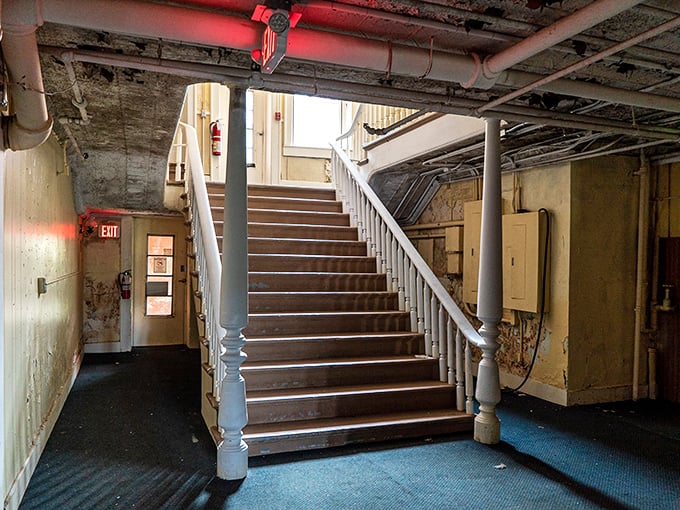 This staircase has witnessed thousands of footsteps over generations, its wooden banister worn smooth by hands seeking stability in uncertain times.
