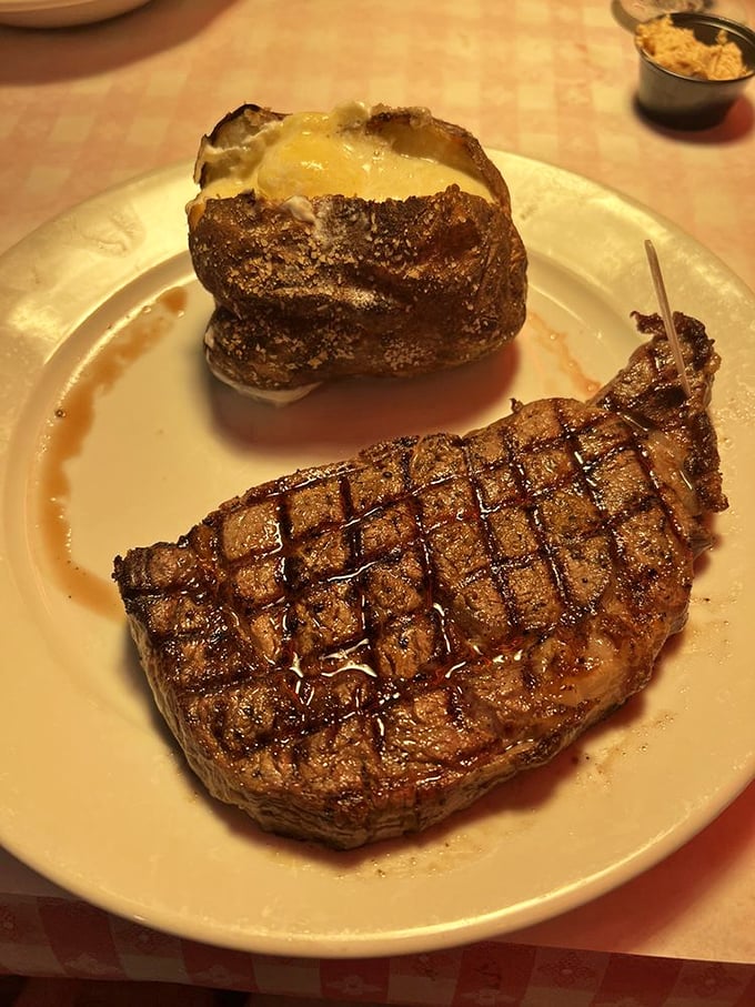 Behold the T-bone in all its grilled glory, accompanied by that perfect fluffy baked potato.