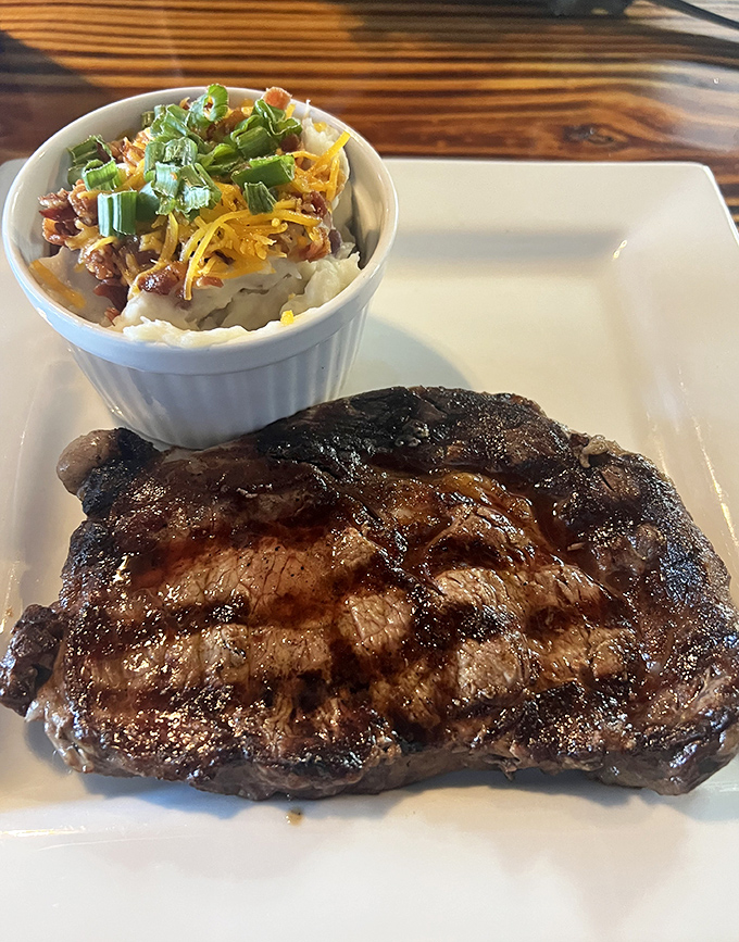 This isn't just a steak; it's a masterclass in simplicity. Perfect char outside, tender inside, with loaded mashed potatoes that deserve their own fan club.