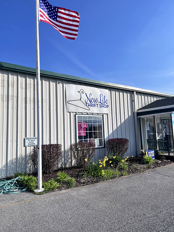 Standing tall under Delaware's blue skies, this thrift shop flies the American flag proudly—patriotism and good deals under one roof.