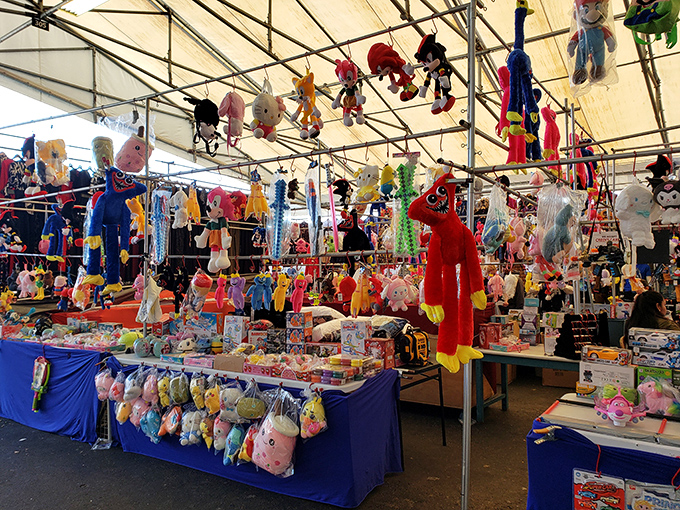 Plush paradise! This toy vendor's stall looks like a cartoon character convention where childhood dreams hang suspended from the ceiling.