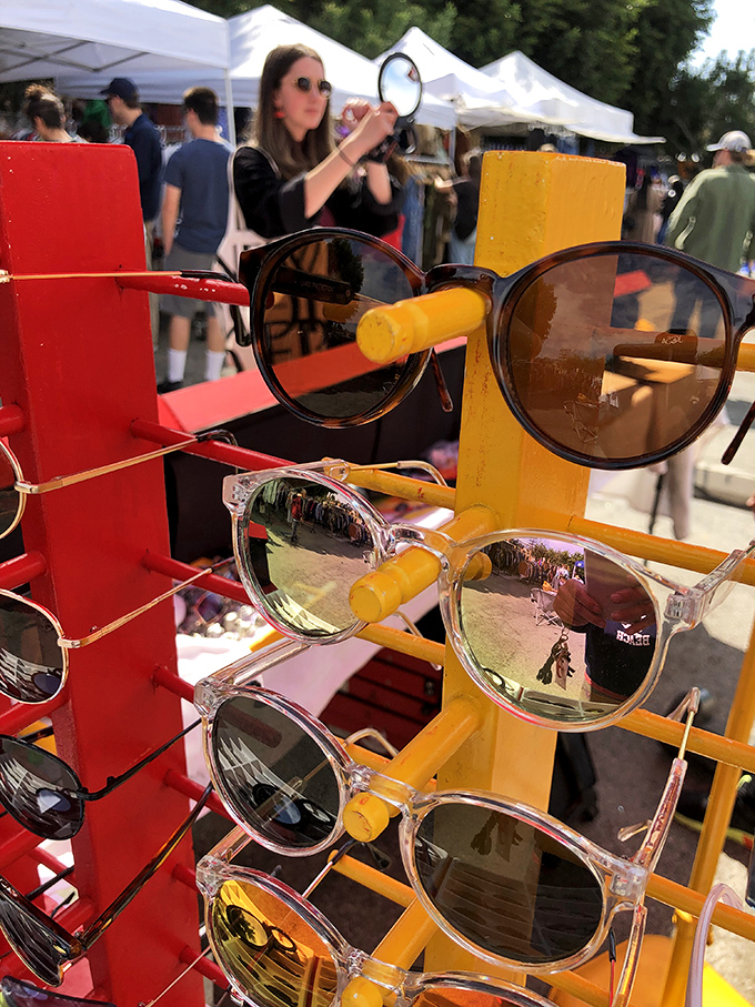 Retro sunglasses catch the light on their colorful display stands&mdash;each pair promising to transform its wearer into a slightly cooler version of themselves.