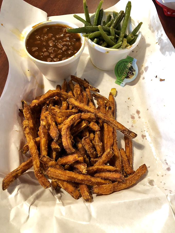 The star of our show: sweet potato fries with perfect crisp-to-fluff ratio, flanked by baked beans and green beans for those pretending to eat vegetables.