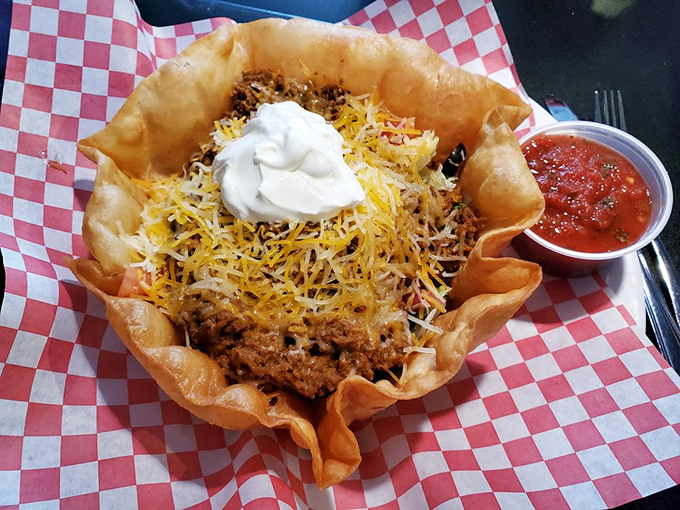 Taco salad reinvented: a crispy tortilla bowl cradling seasoned beef, cheese, and sour cream. Comfort food that doesn't pretend to be anything but delicious.