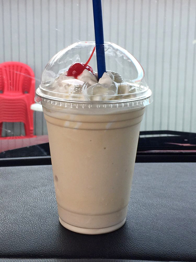 The vanilla shake arrives like a cloud in a cup, crowned with whipped cream and that essential cherry. Spoon or straw? The eternal dilemma begins.