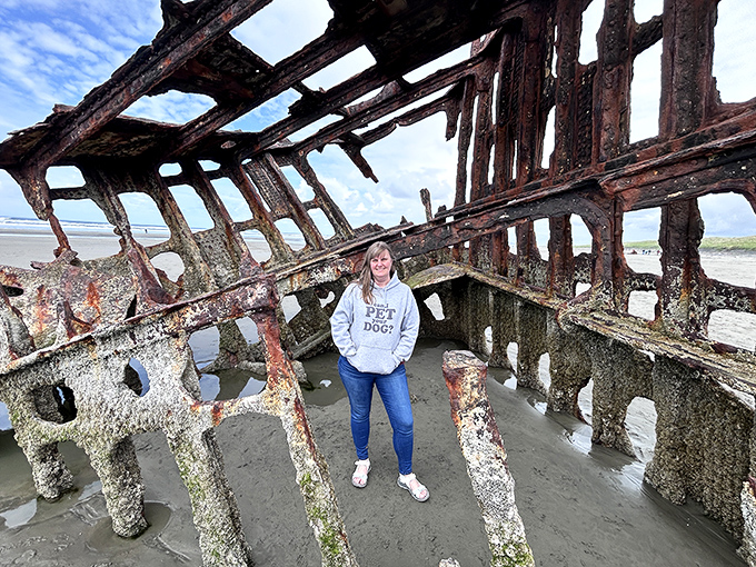 Inside the belly of maritime history! The Peter Iredale's remaining structure creates a natural frame for visitors seeking that perfect Oregon coast memory.