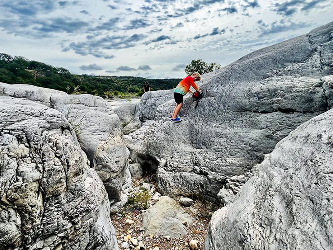 Rock climbing or interpretive dance? This adventurer navigates Pedernales' limestone playground, where every handhold tells a 300-million-year-old story.