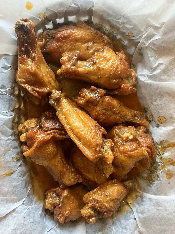 These wings aren't just cooked, they're transformed &ndash; crispy exterior giving way to juicy meat that practically demands a moment of respectful silence.