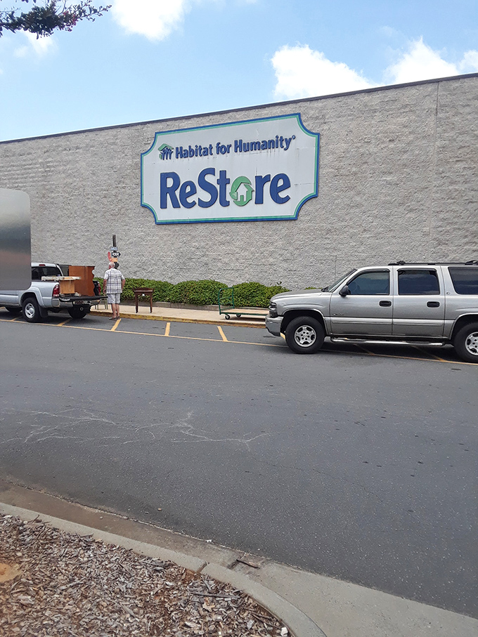 Habitat's ReStore sign stands proud against the stone facade. Where your purchase of a gently-used lamp helps build someone's future home.