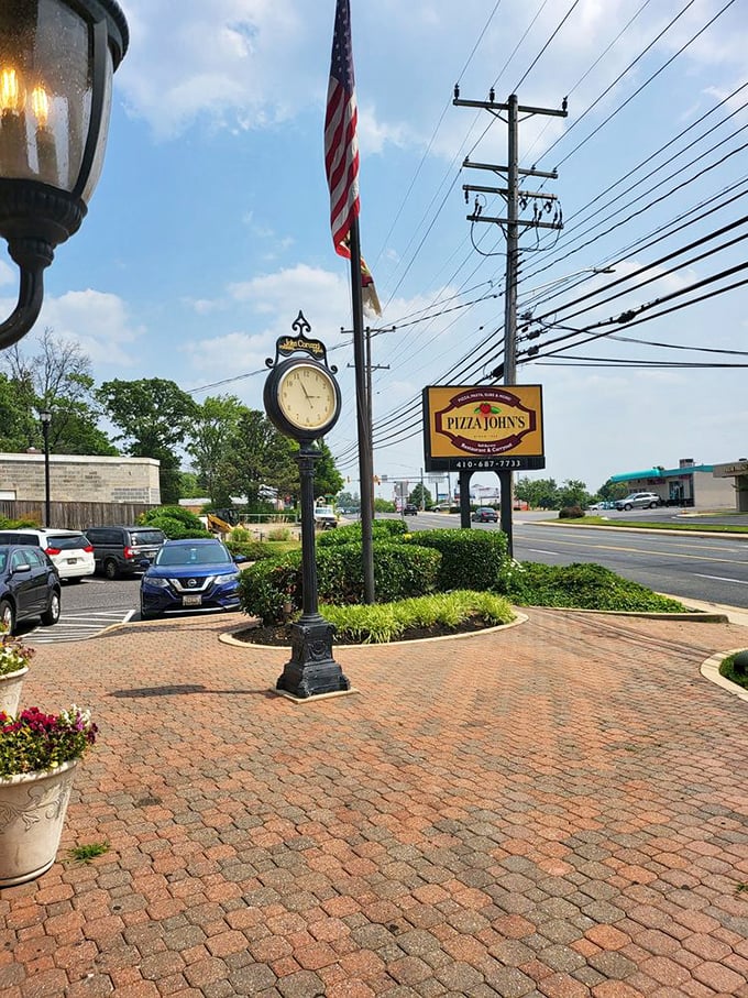 Pizza John's stands proud with its American flag and vintage clock. This Essex institution has been telling pizza time for decades.