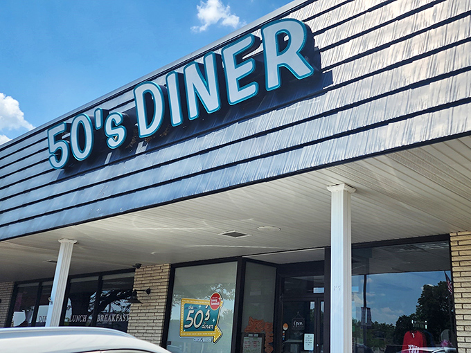 The 50's Diner's blue metallic facade shimmers with promises of milkshakes and morning classics.