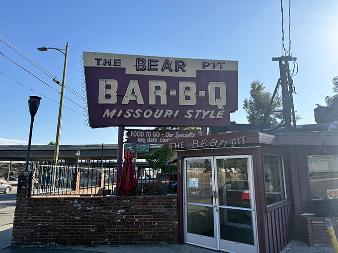 That vintage purple sign has been guiding hungry souls to BBQ salvation since before Instagram could make food famous.